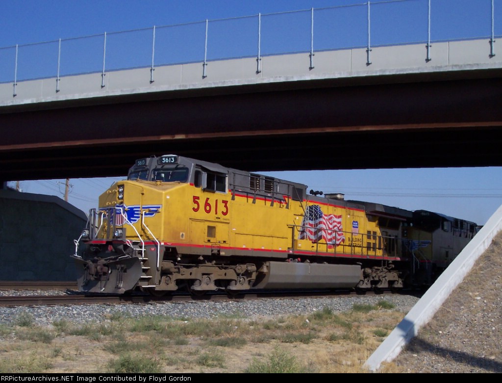 UP 5613 pushs on westbound UP freight
